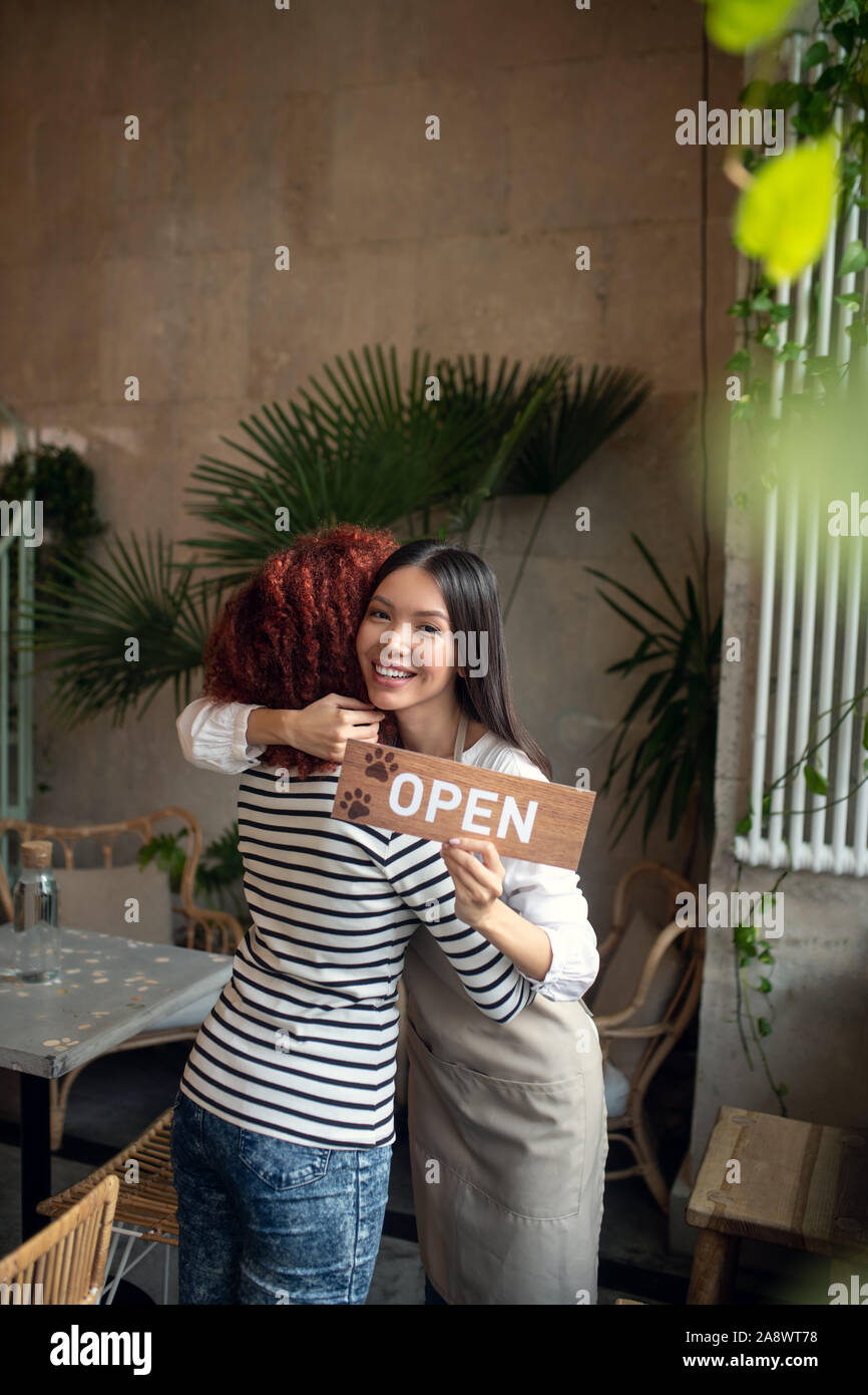 Entrepreneur hugging her best friend thanking for support Stock Photo ...