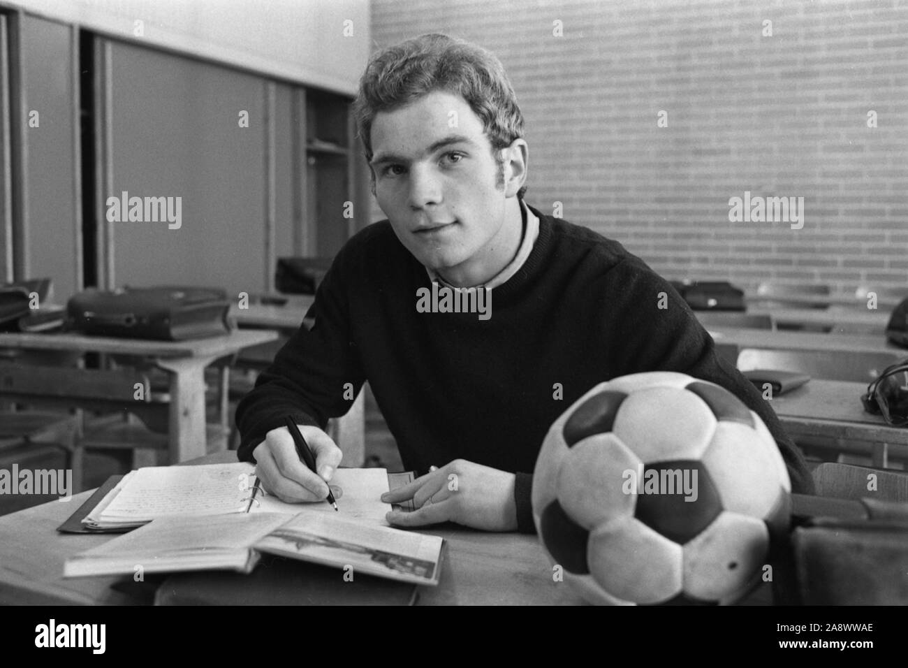 Uli HOENESS (Honess, Honess), footballer, sitting on a school desk and ...