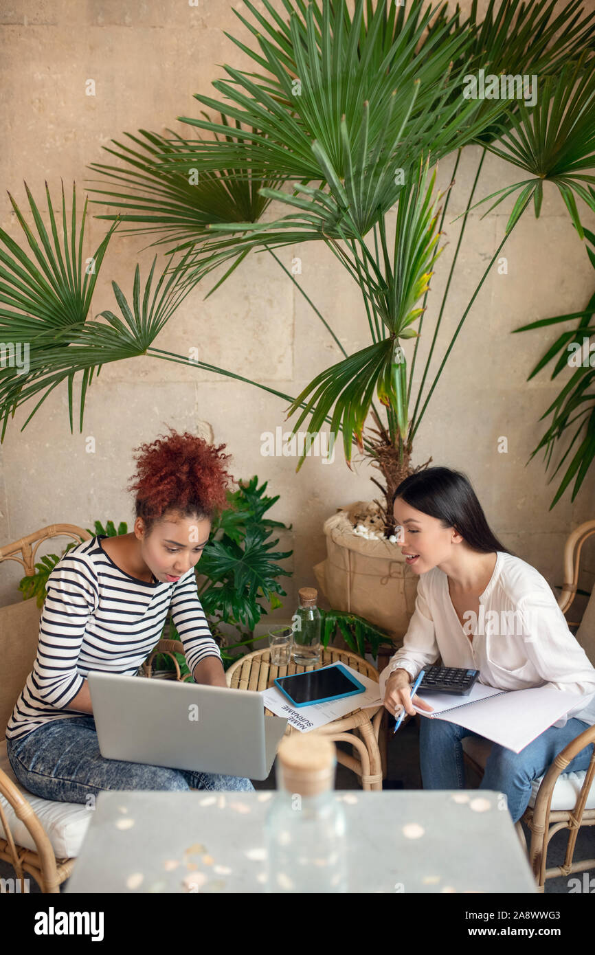 Two women feeling involved in making financial report Stock Photo - Alamy
