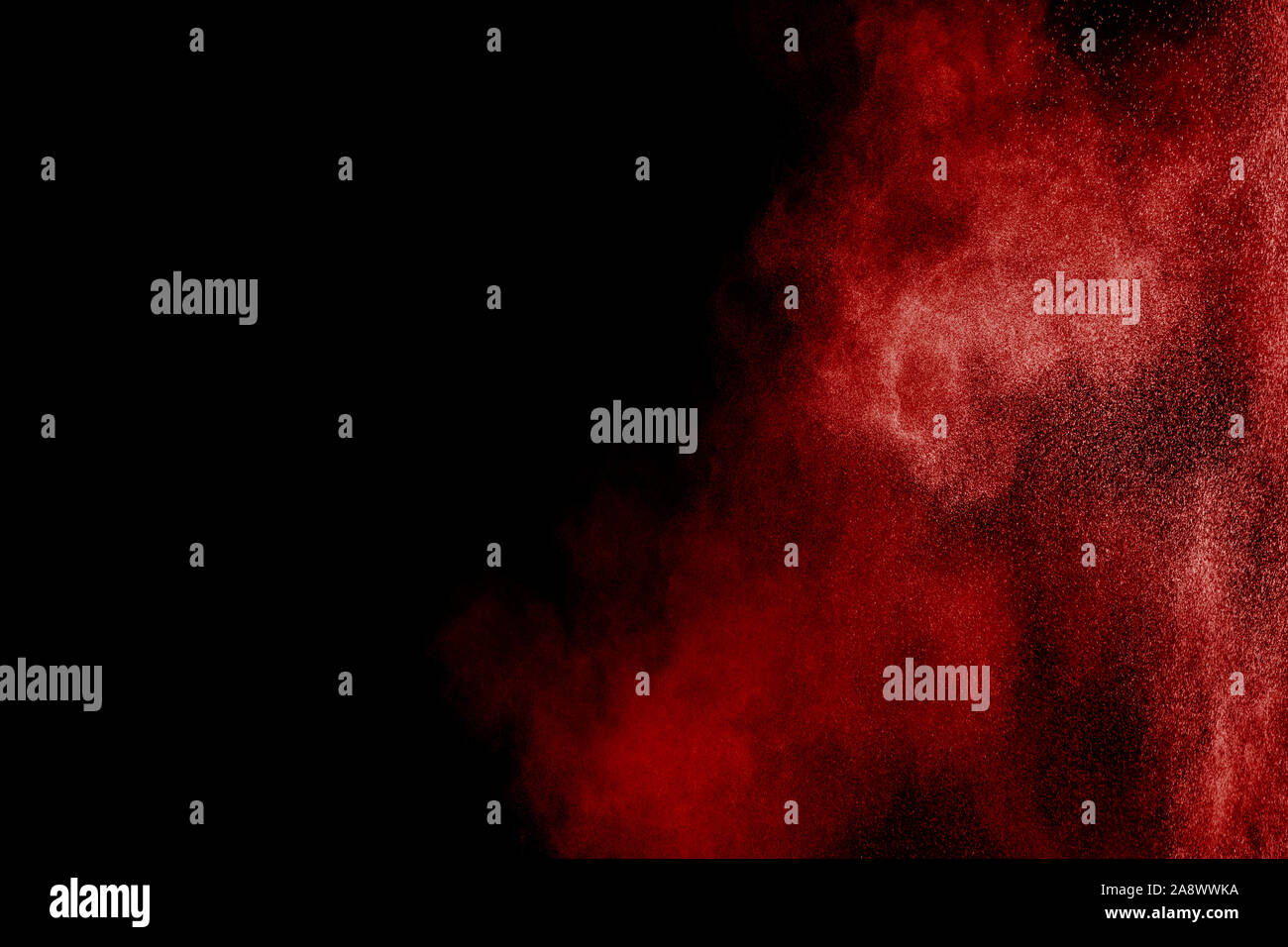 Red powder explosion on black background. Freeze motion of red dust ...