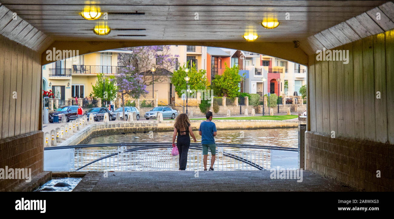 Couple walking through an underpass to Claisebrook Cove East Perth ...
