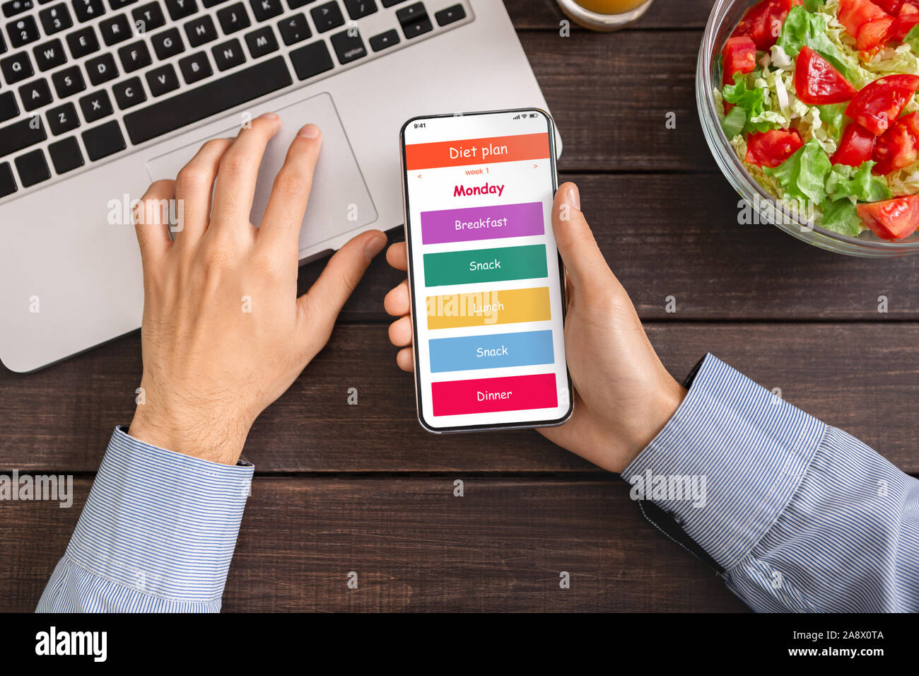 Man using laptop and smartphone with daily diet plan application Stock ...