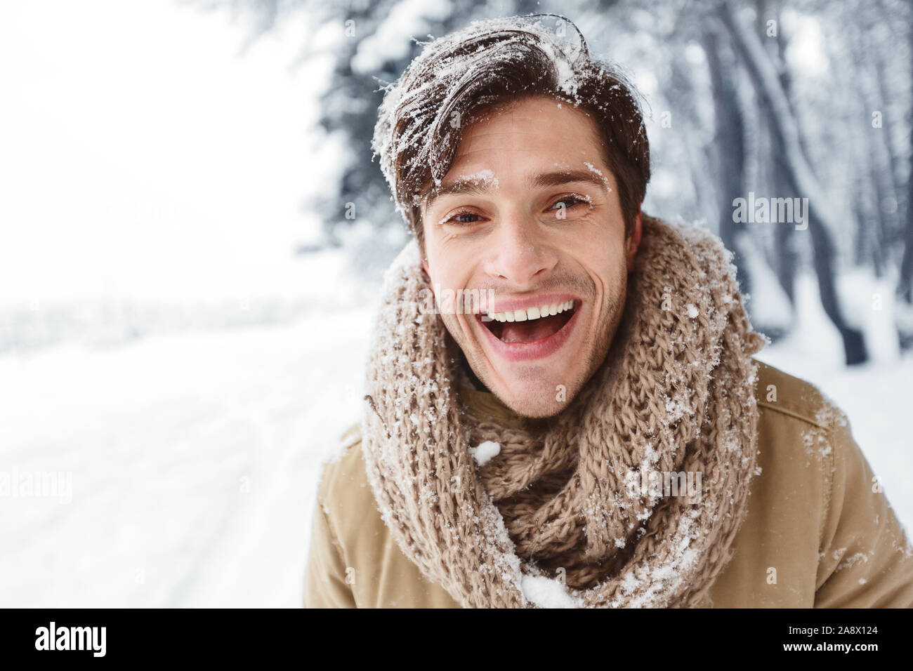 Guy Smiling At Camera Standing In Winter Forest Stock Photo - Alamy