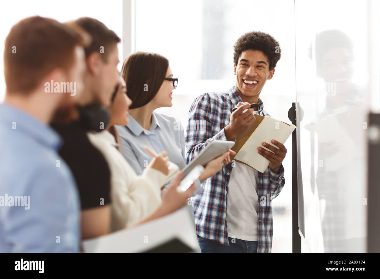 Learning concept. Students discussing tasks on whiteboard Stock Photo ...