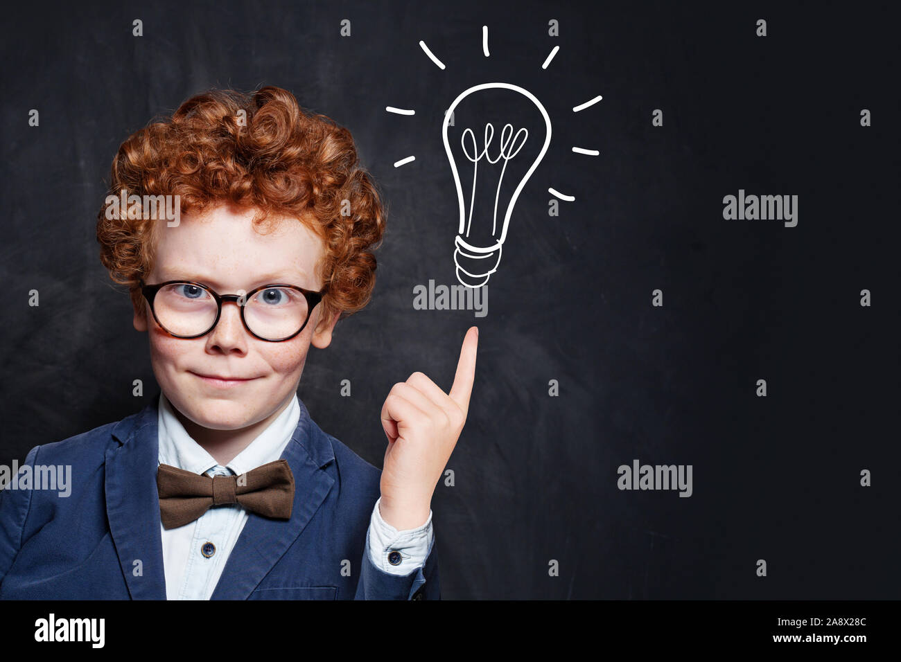 Successful child boy showing lightbulb. Brainstorming and idea concept ...