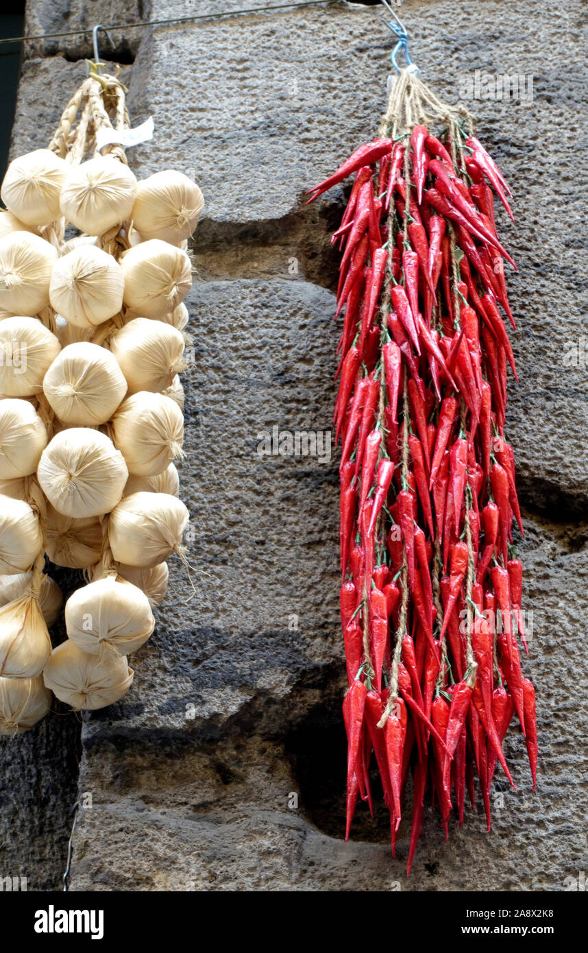 Hot red chilli peppers and cloves of fresh garlic at a greengrocer in ...