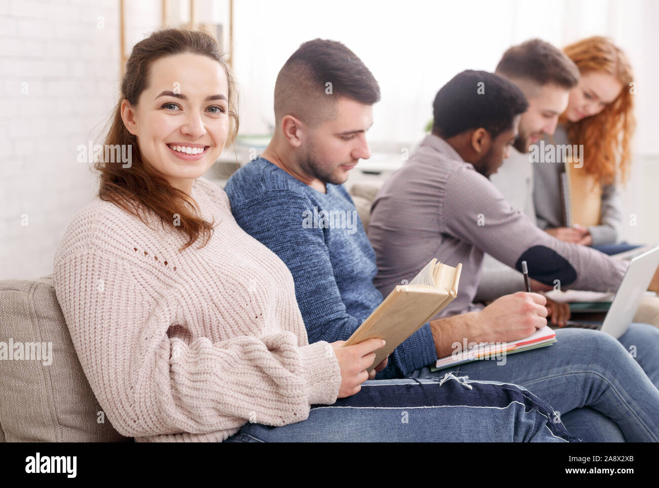 Happy student girl reading book, preparing for exam Stock Photo - Alamy