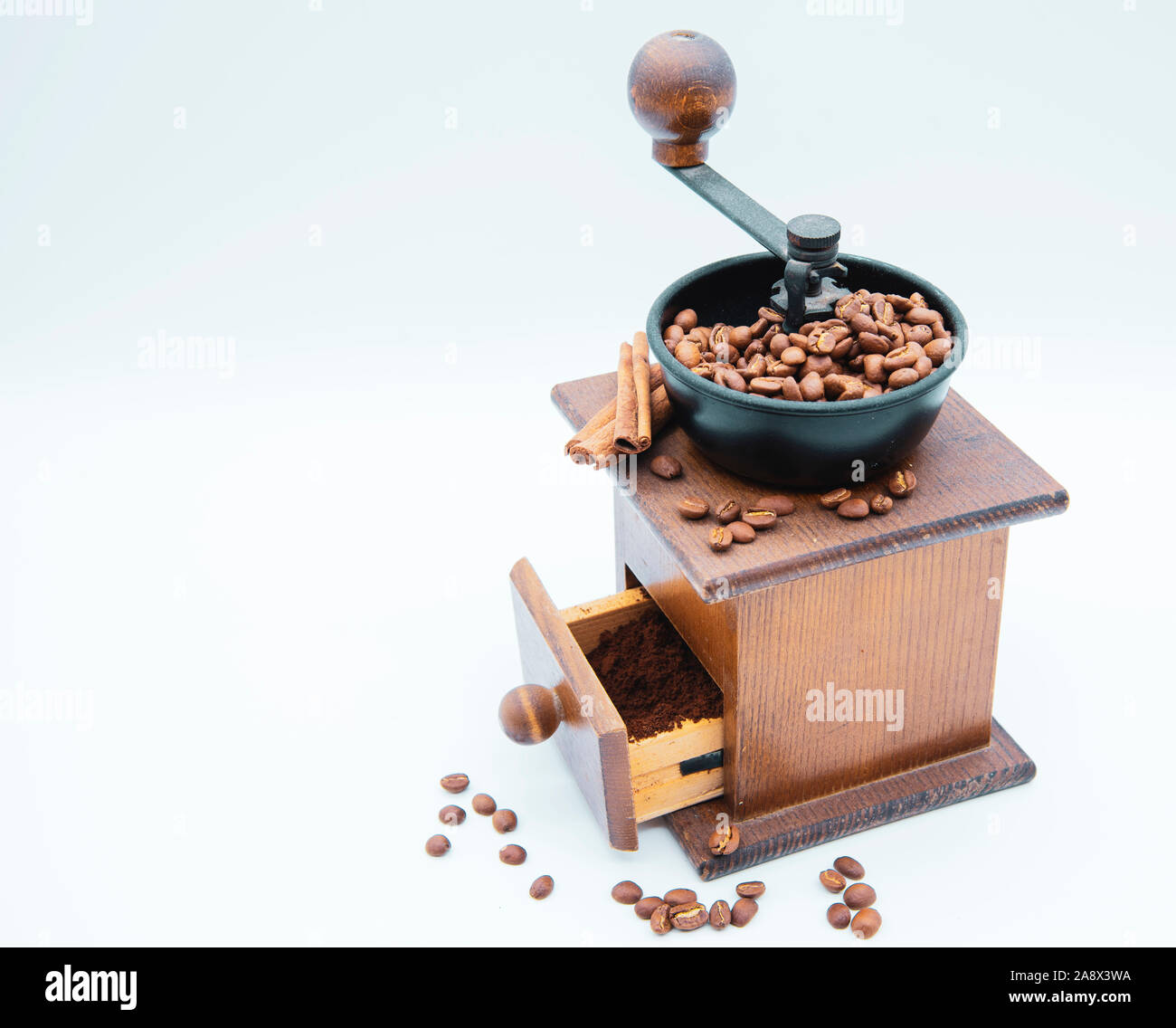 Wooden hand grinder in retro style on a light background Stock Photo ...