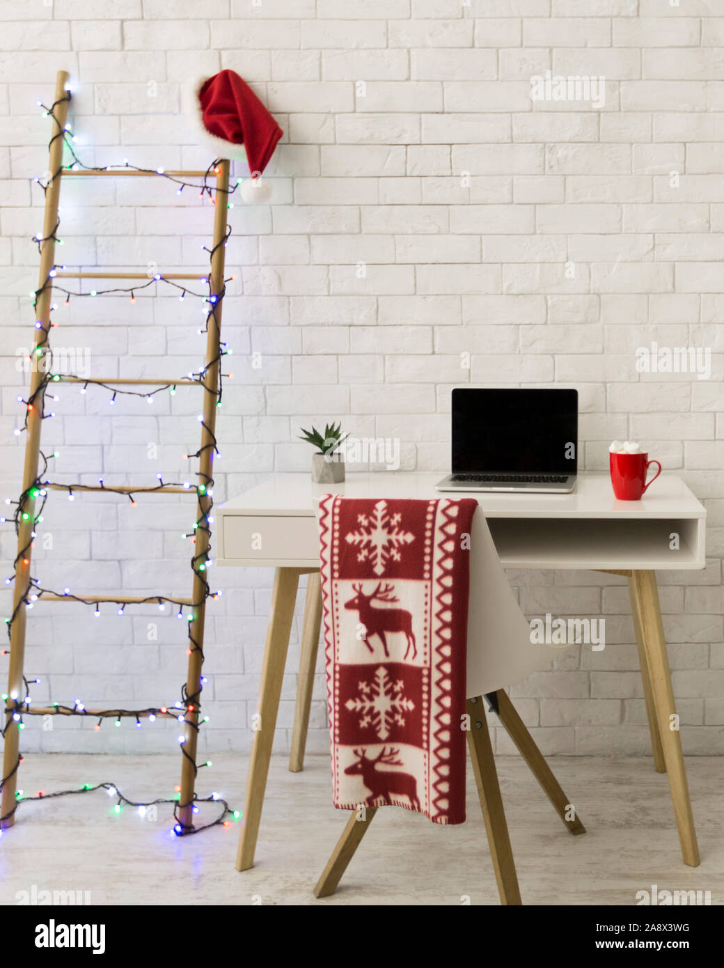 Santa's workplace with black modern laptop and ladder Stock Photo - Alamy