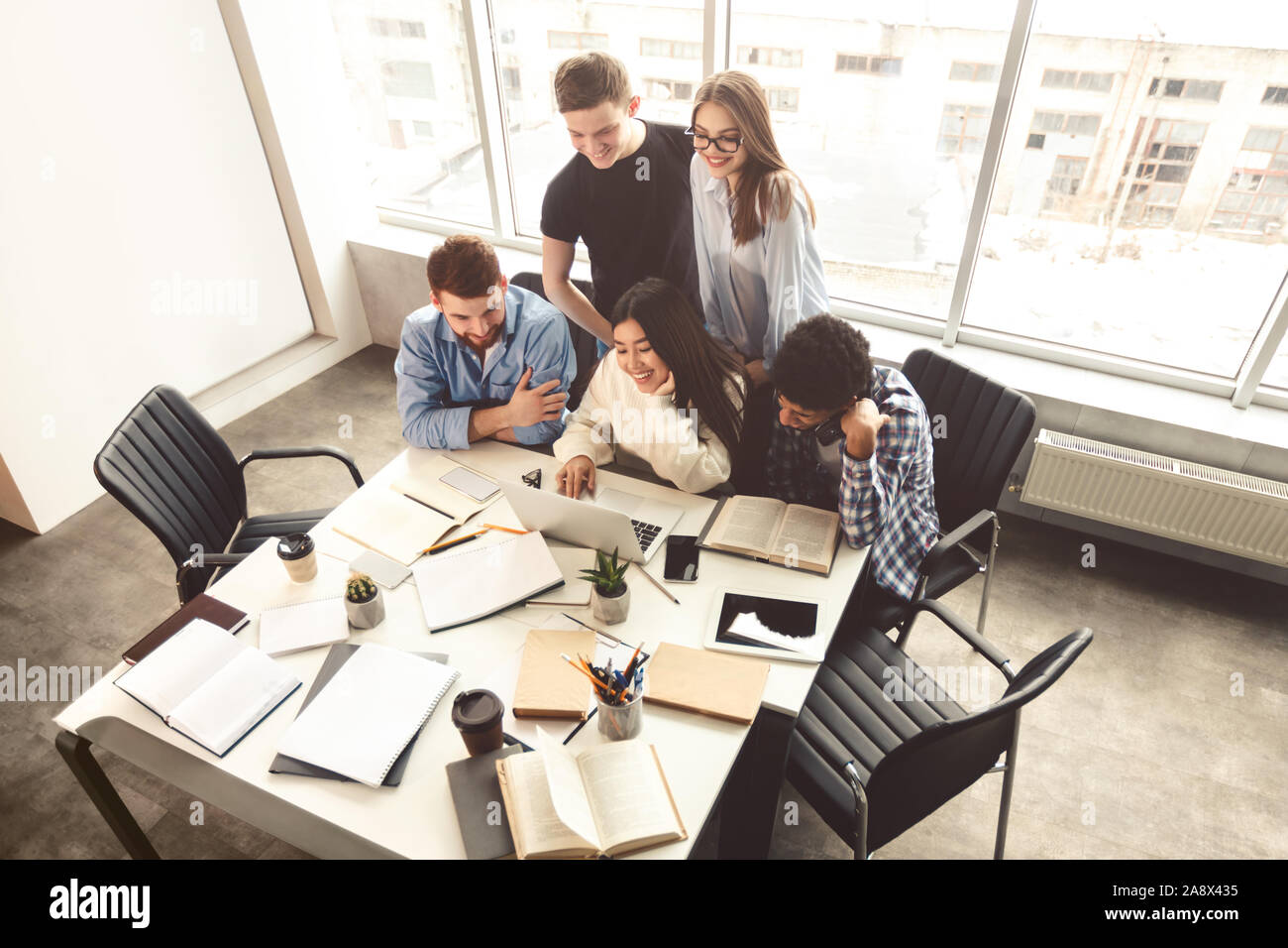 Group of students working together on school assignment Stock Photo - Alamy