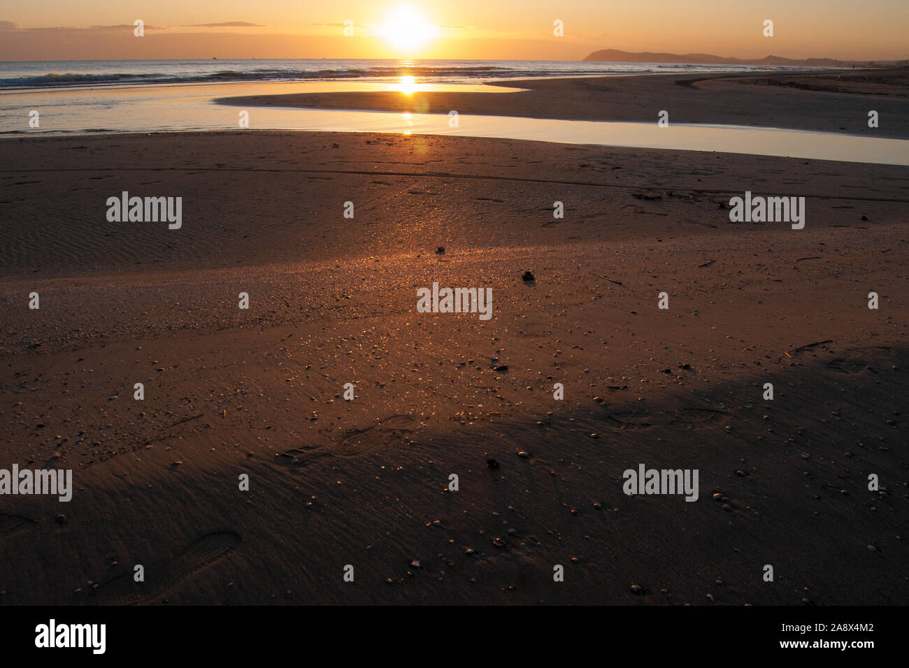 sunset view sea , sun and golden sand on the beach Stock Photo - Alamy
