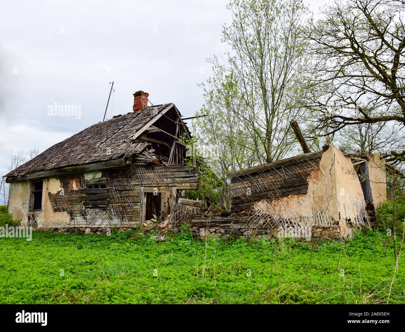 : landscape with old and collapsed country house, collapsed wall and ...