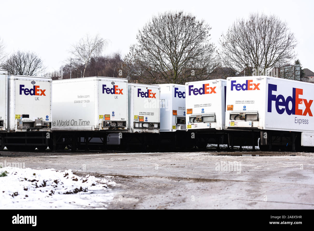 Fed Ex lorries ready having maintenance and being loaded with parcels ...