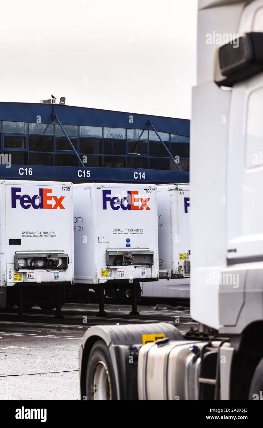 Fed Ex lorries ready having maintenance and being loaded with parcels ...