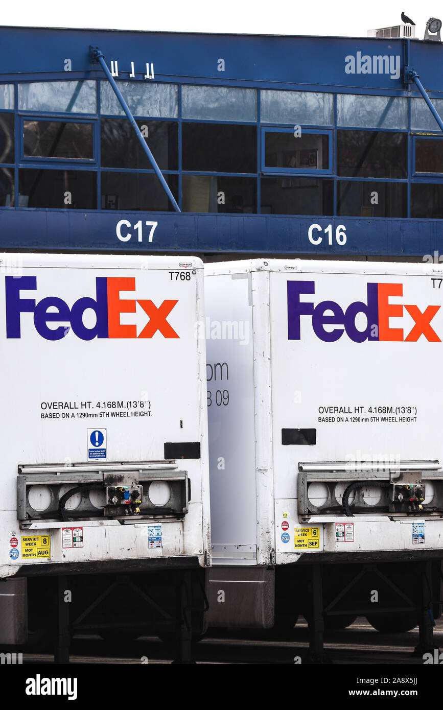 Fed Ex lorries ready having maintenance and being loaded with parcels ...