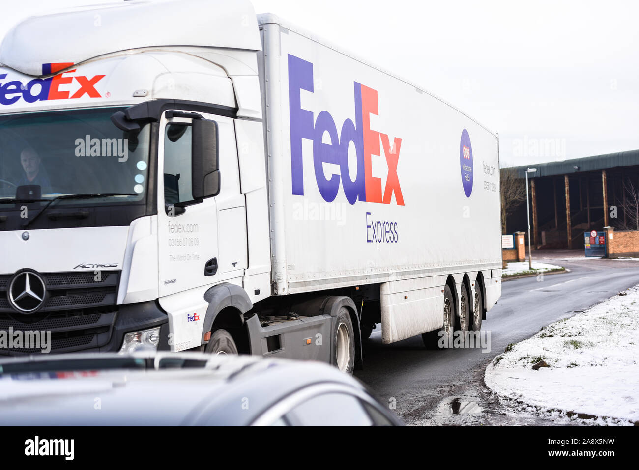 Fed Ex lorries ready having maintenance and being loaded with parcels ...