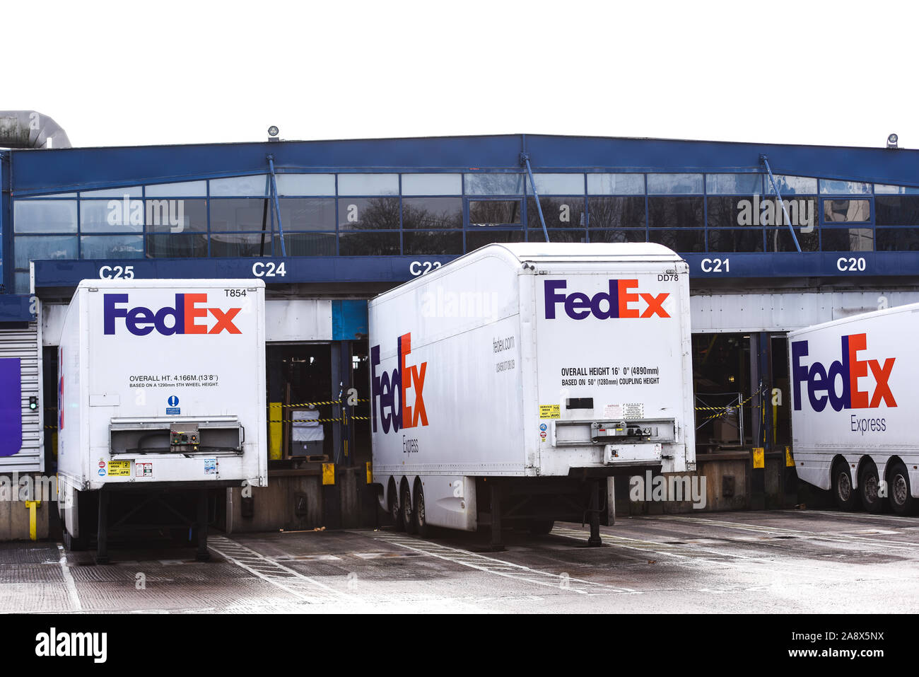 Fed Ex lorries ready having maintenance and being loaded with parcels ...