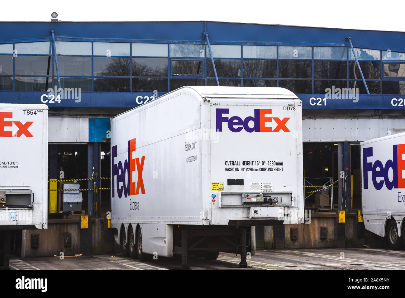 Fed Ex lorries ready having maintenance and being loaded with parcels ...