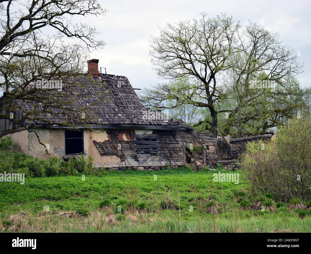 : landscape with old and collapsed country house, collapsed wall and ...