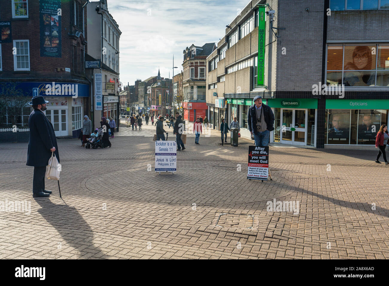 A Christian street preacher, evangelist talking to the public about god ...