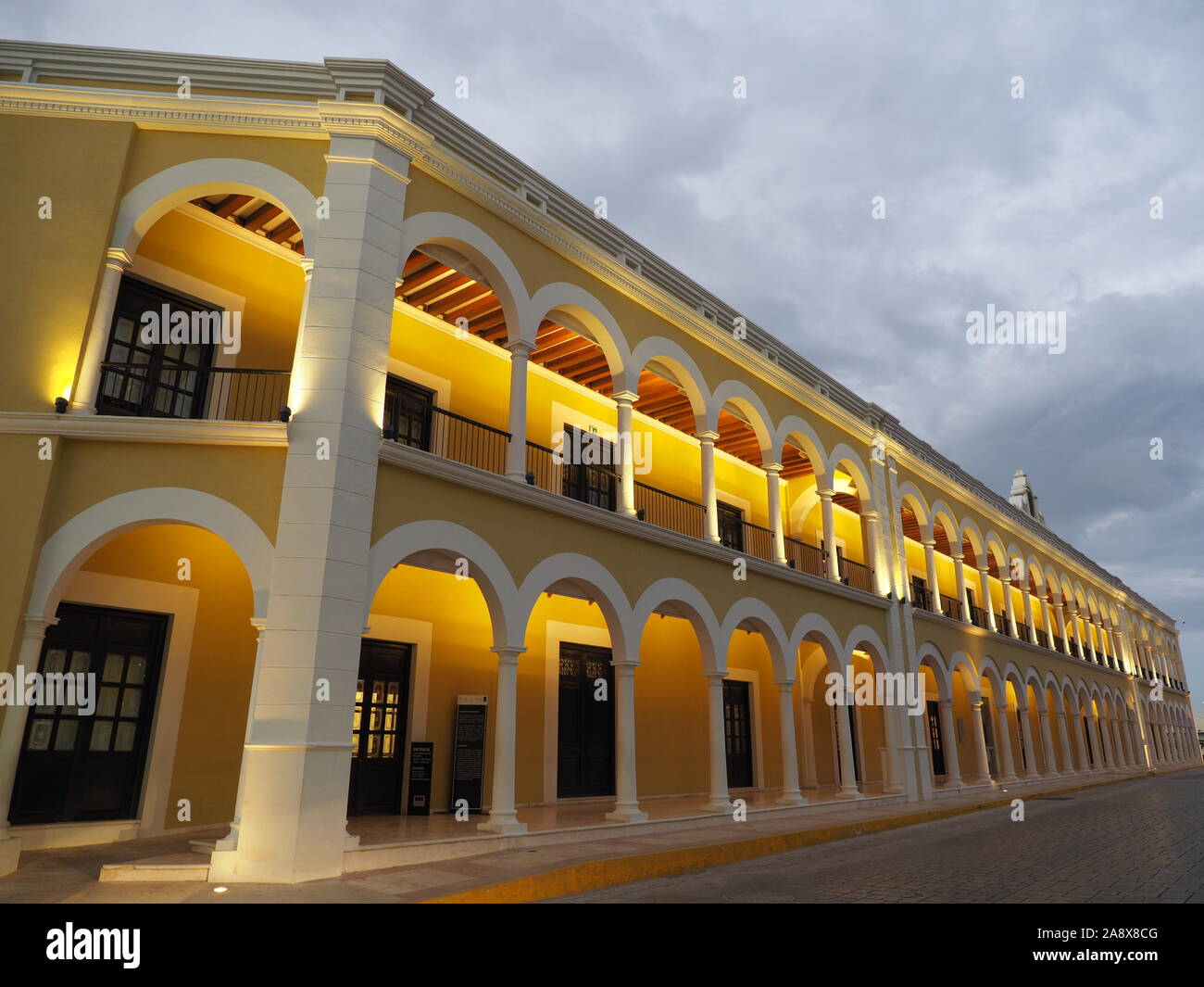 Yellow colonial building with arcade at street in San Francisco de ...