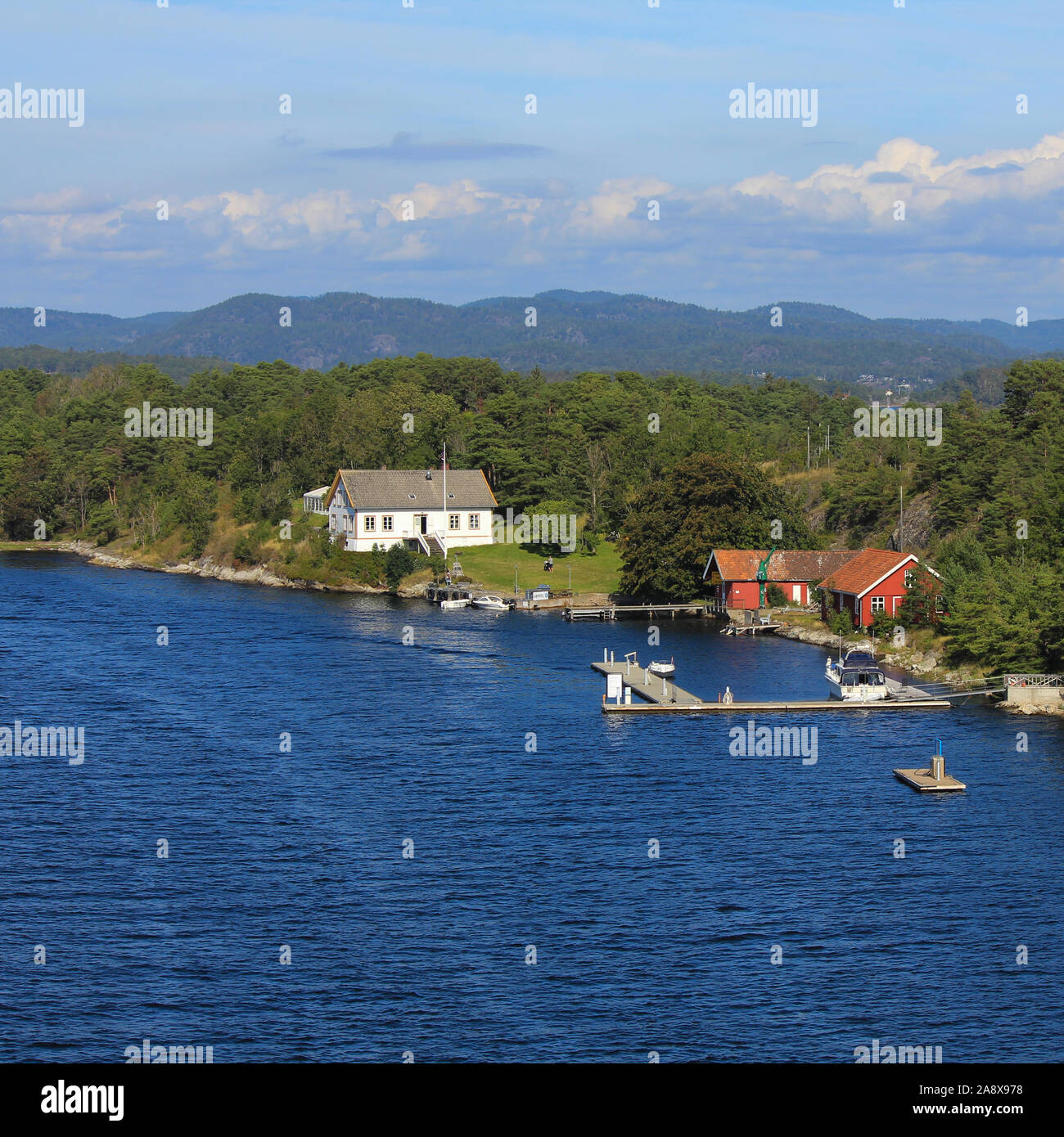 Green forest and houses on the shore in Langesund, Norway Stock Photo ...