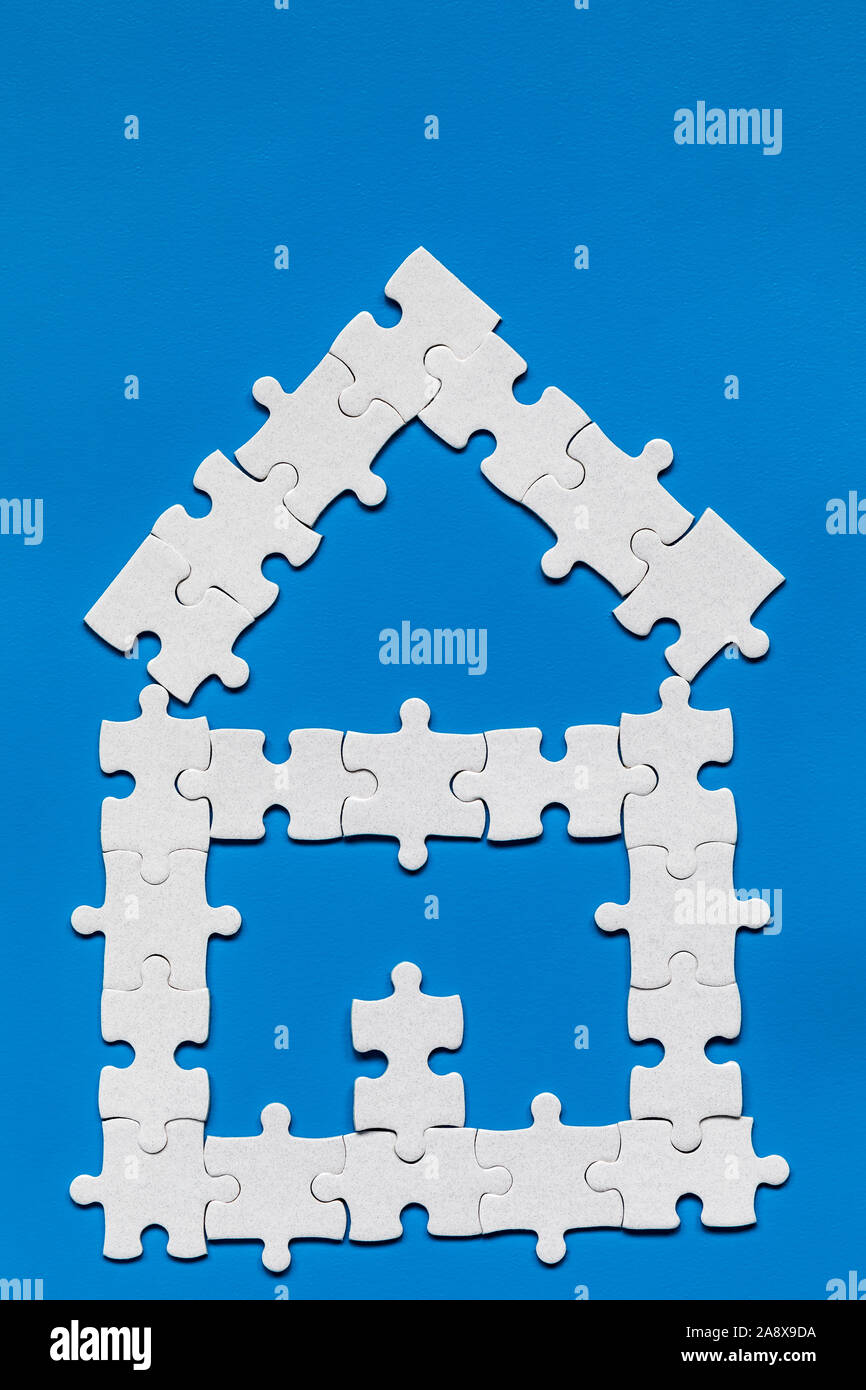 House made of puzzles. Modern house puzzle white pieces for concept ...