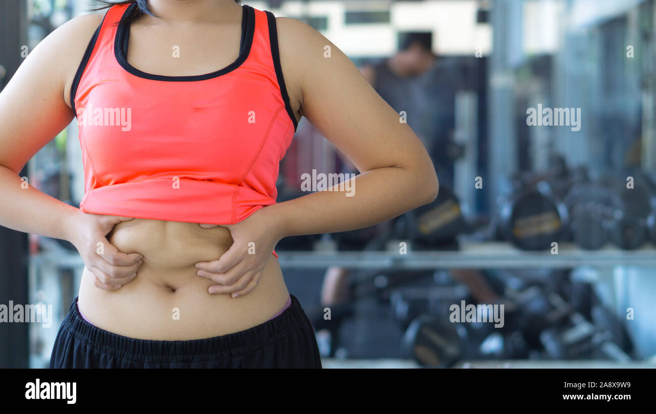 Close up woman holding excessive fat belly. Woman overweight abdomen ...