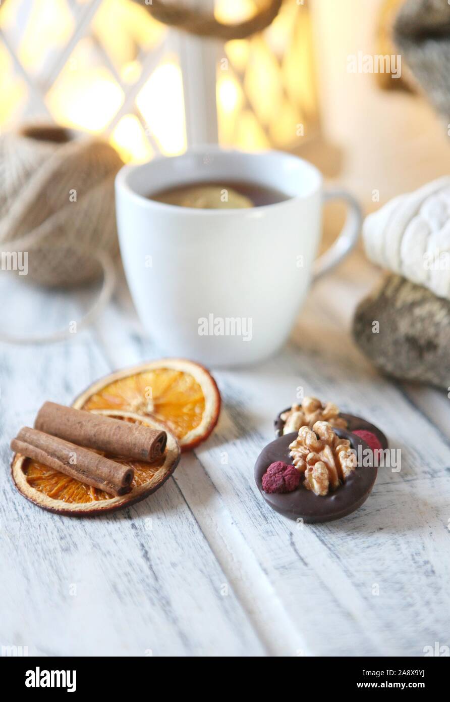 White cap of tea with lemon. Mix nuts, dry fruits and chocolate on a ...