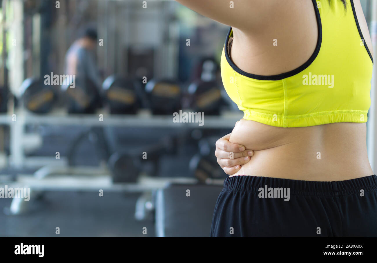 Close up woman holding excessive fat lower back. Woman overweight ...