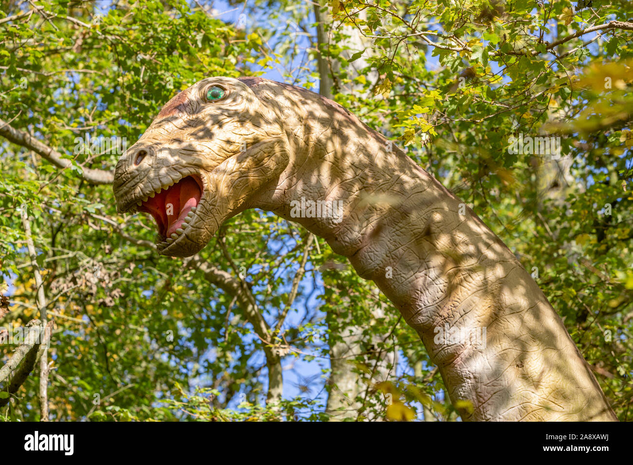 A Model Dinosaur in woodland Stock Photo - Alamy