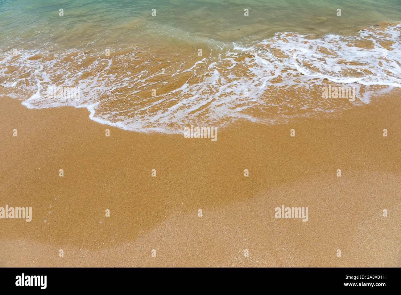 Blue ocean wave on sandy beach. Soft wave of blue ocean on sandy beach ...