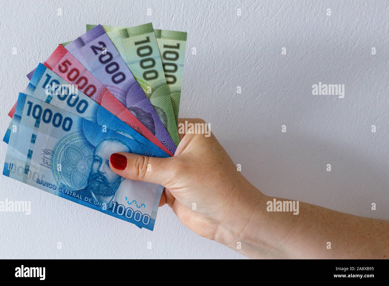 Chilean pesos, banknotes in a woman's hand Stock Photo - Alamy