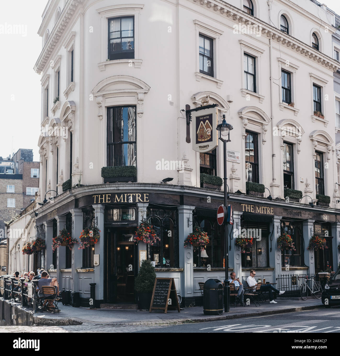 London, UK - July 18, 2019: People sitting outside The Mitre pub in ...