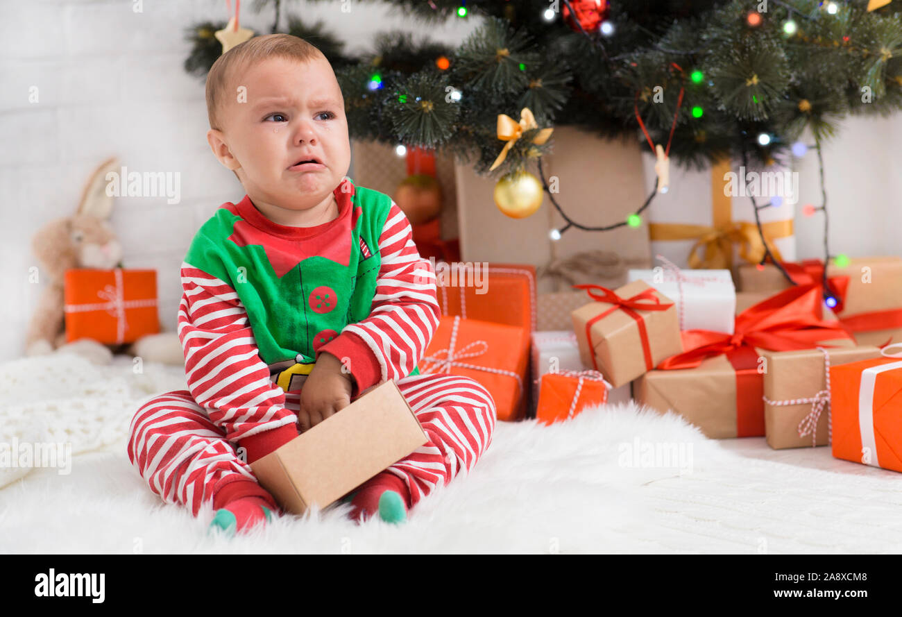 Crying baby elf missed his Christmas gift Stock Photo - Alamy