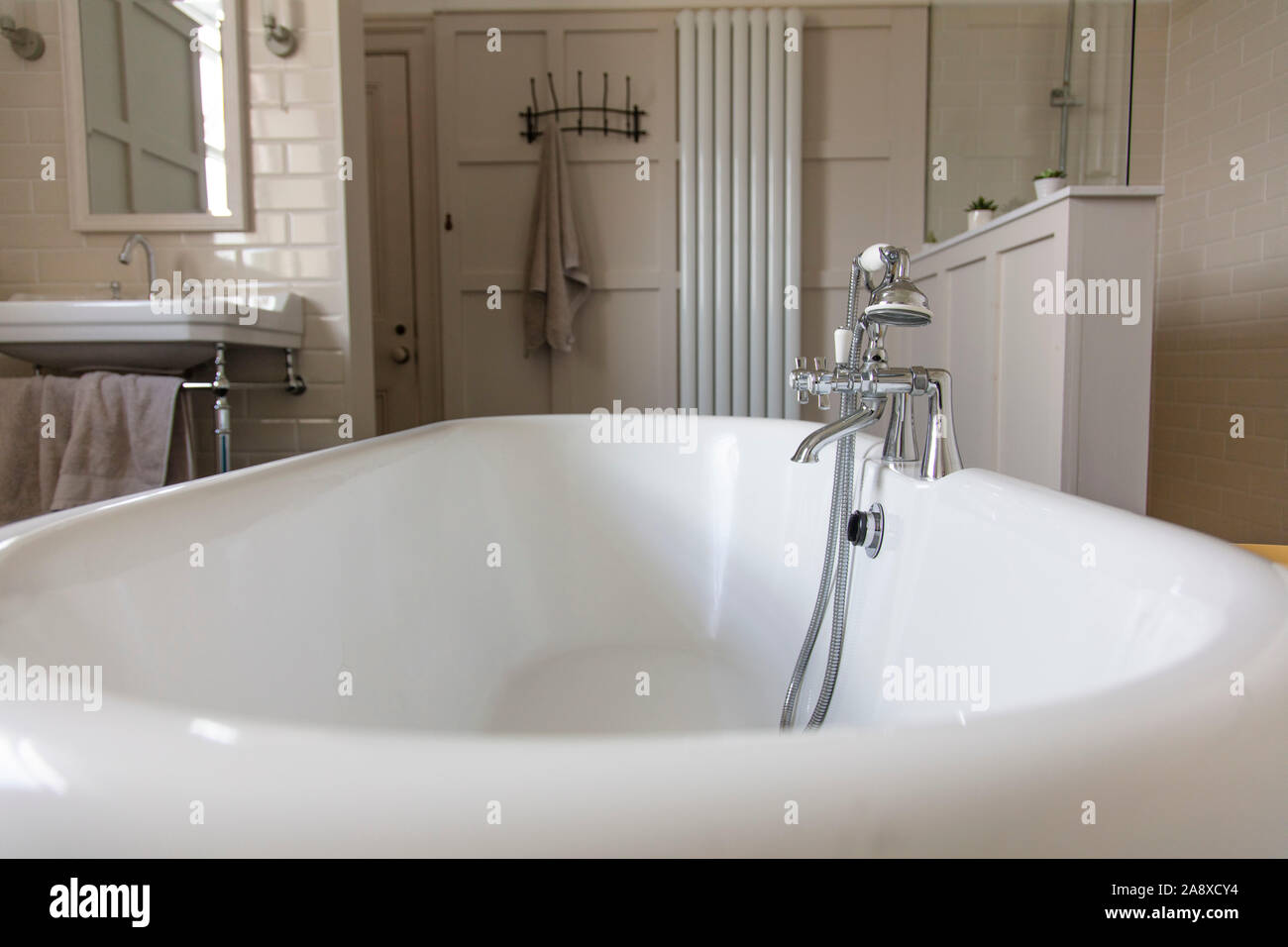 Luxury bathroom interior with classic rolltop bath tub and vintage tap ...