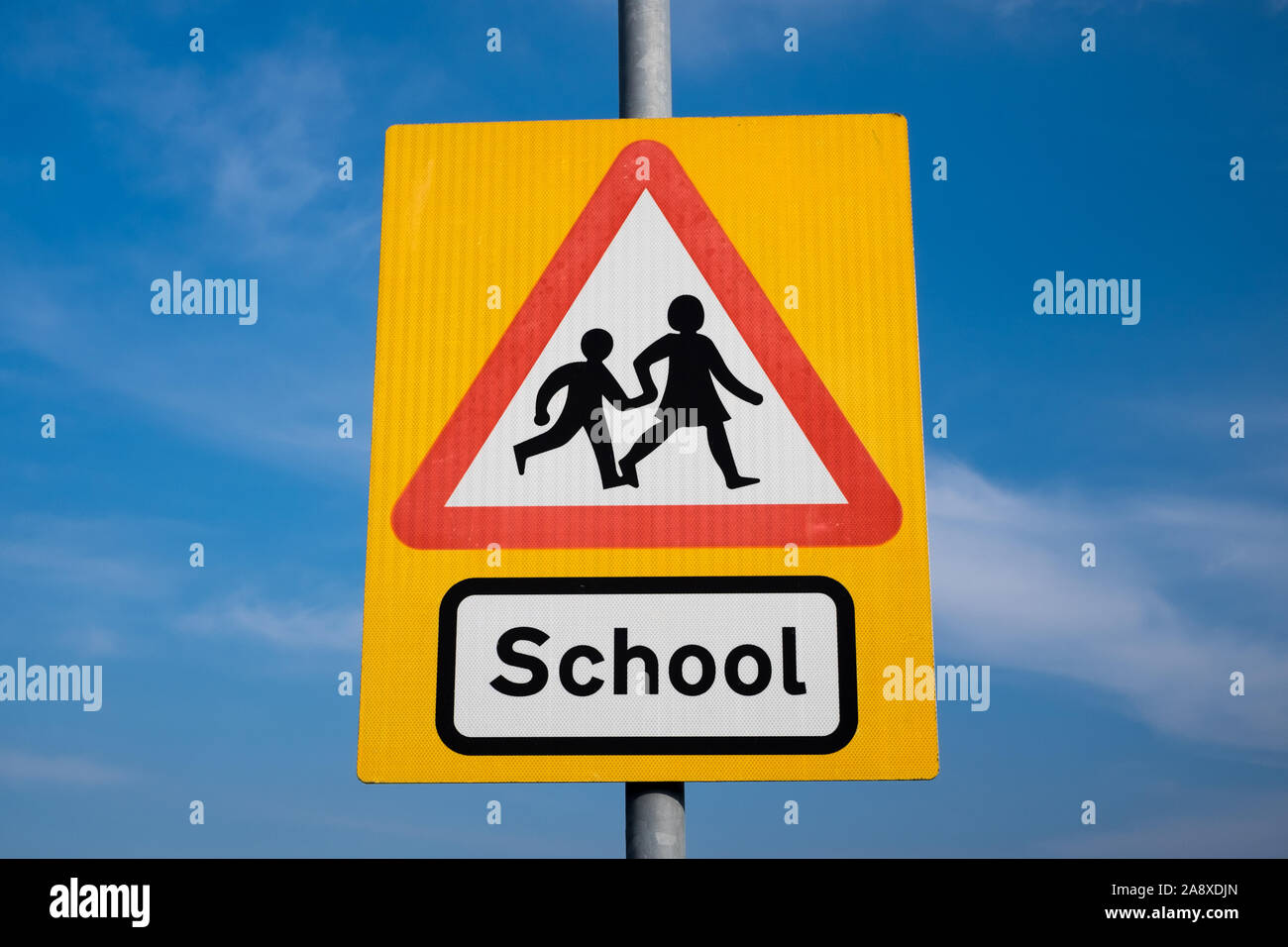 School kids crosswalk sign. Yellow with blue sky Stock Photo - Alamy
