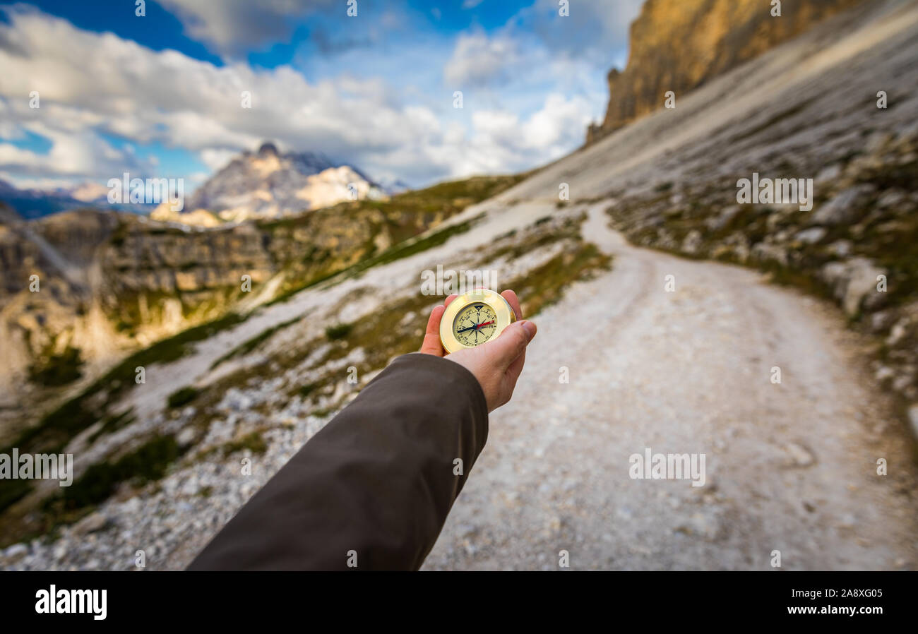Explorer searching direction with compass in summer mountains, point of ...