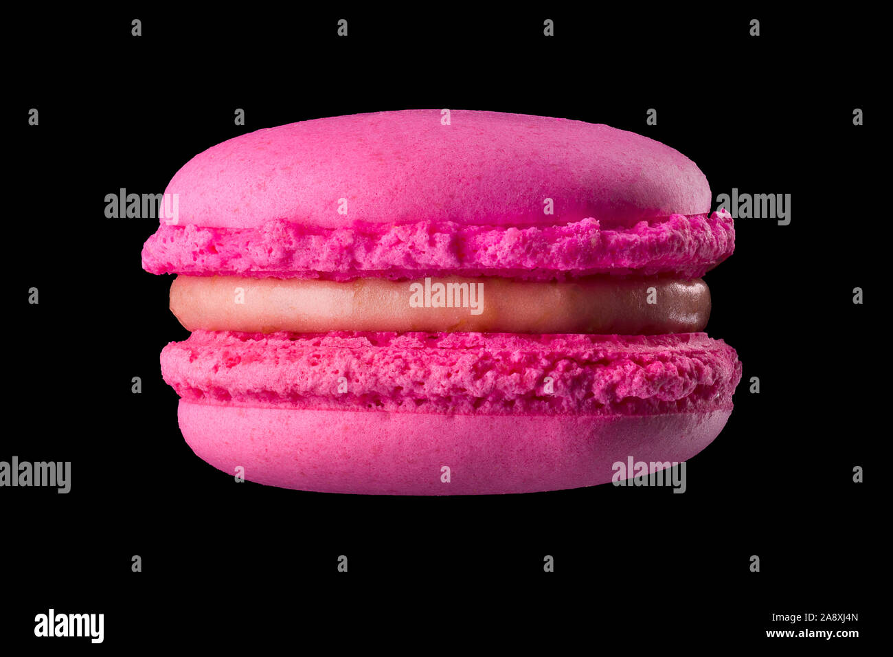 Macro photo of french pink rose macaroon isolated on black with ...