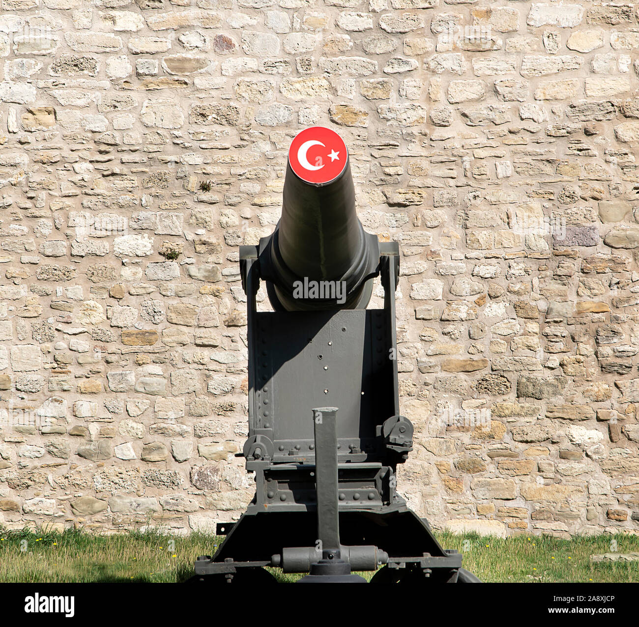 An antique Turkish cannon used in the World War I with castle wall on ...