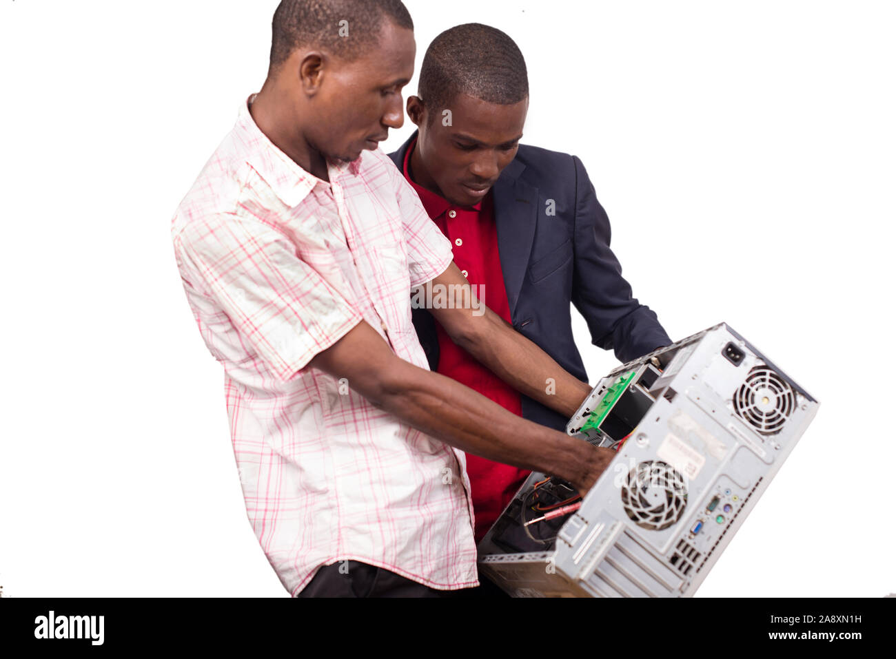 Technician repairing a broken down computer in an office in front of ...