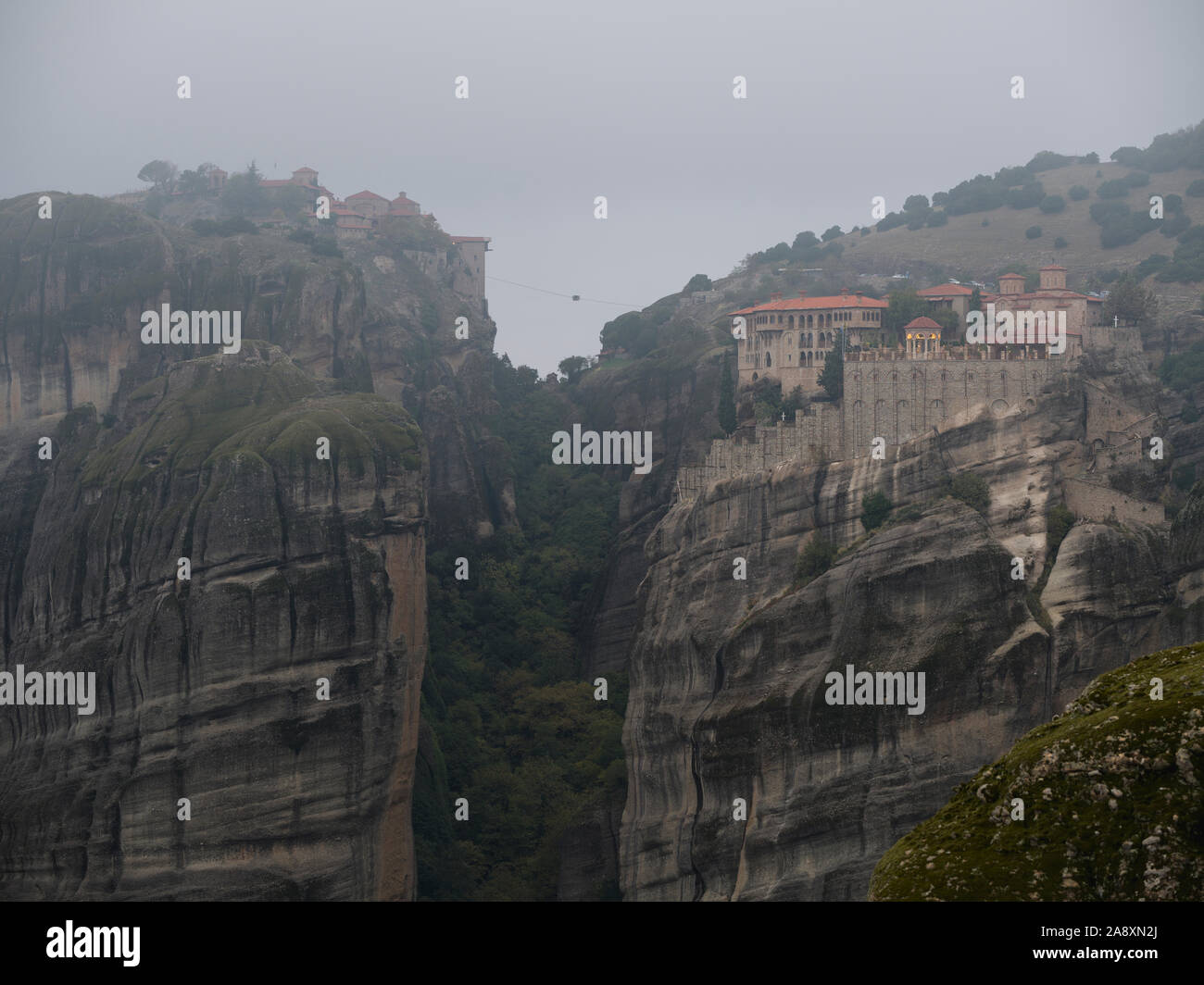 Rope bridge between Meteora Monasteries in the fog Stock Photo - Alamy