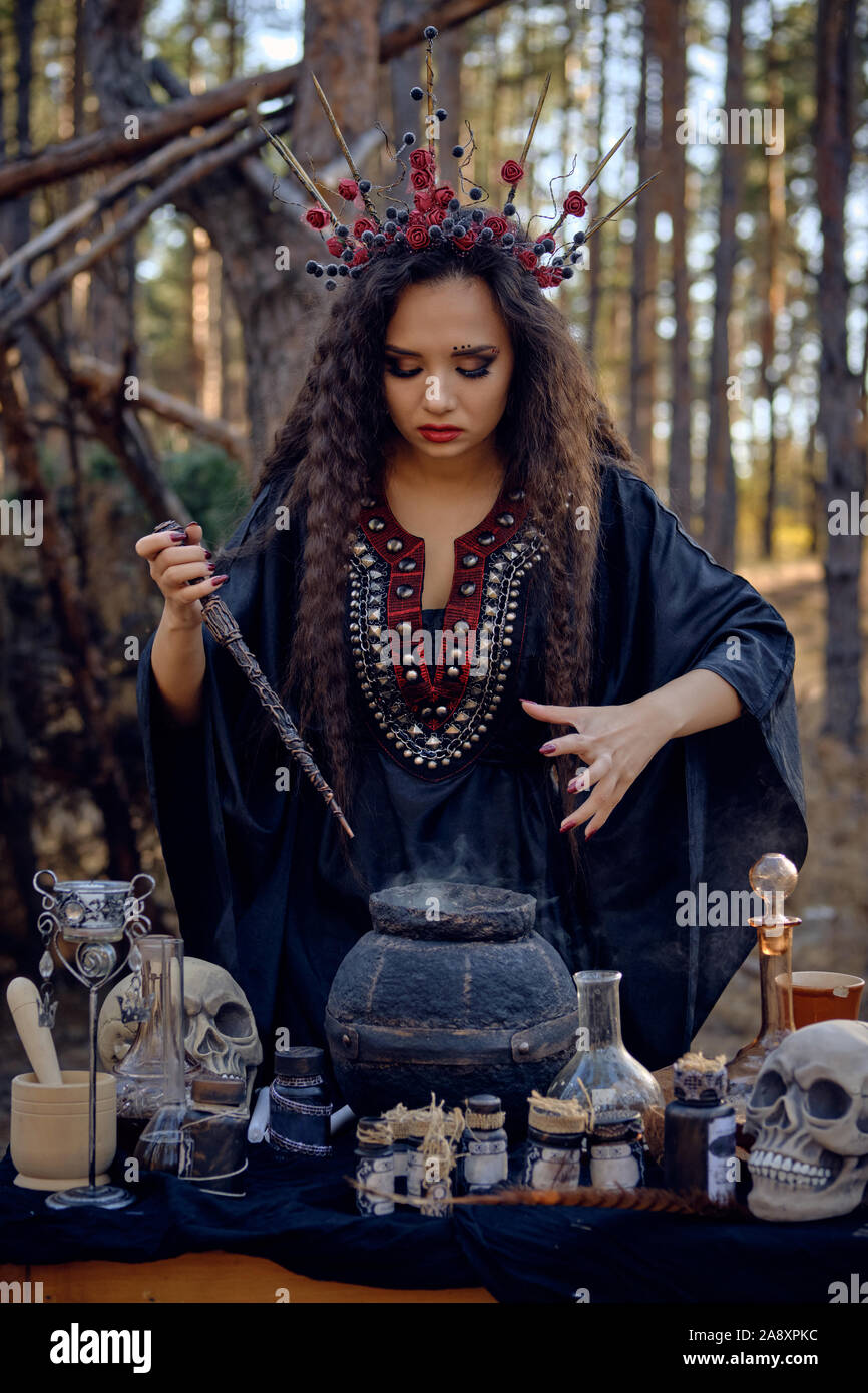 Cute, wicked, long-haired charmer in a black, long embroidered dress ...