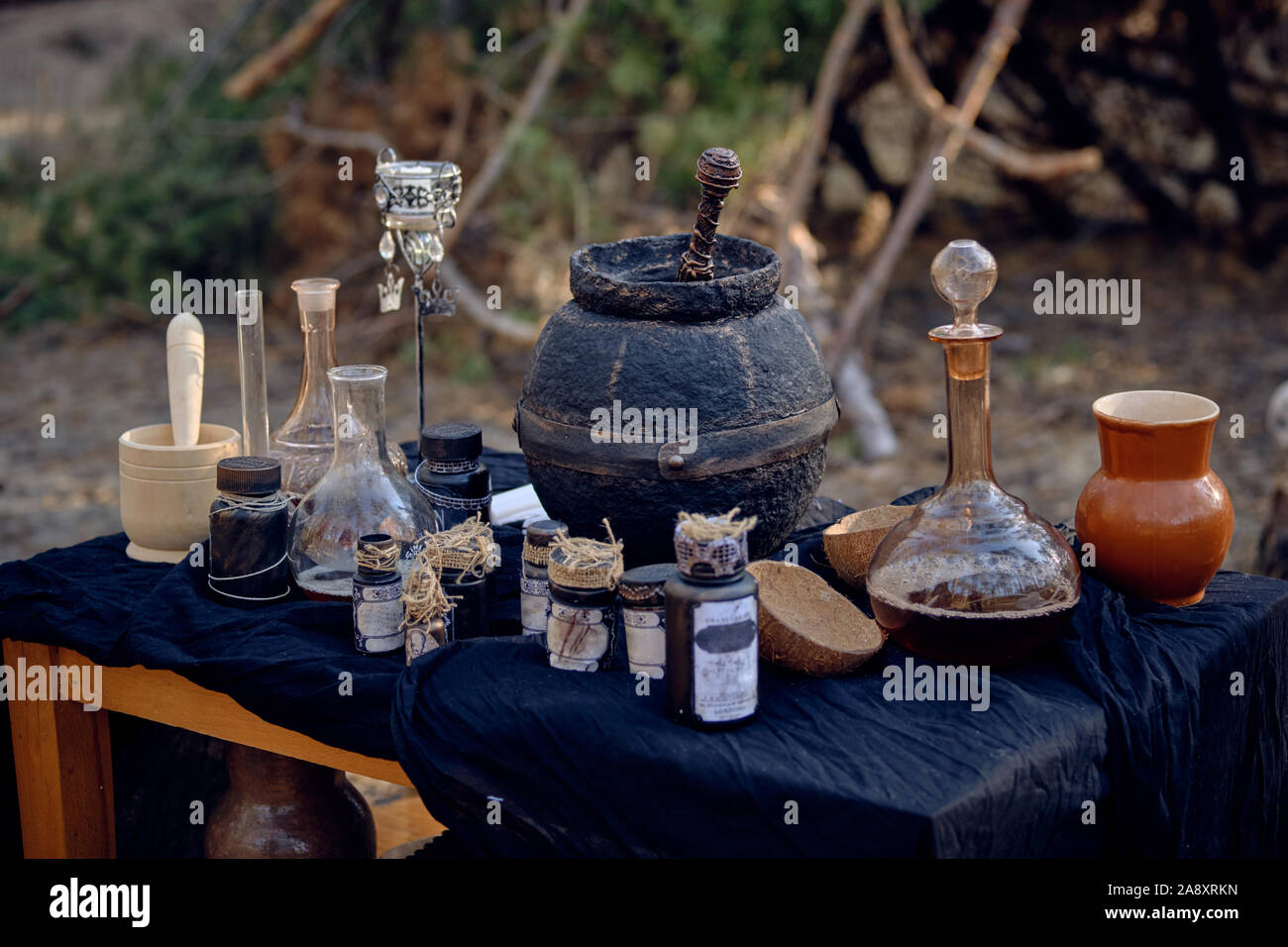 Table with accessories for spells and witchcraft standing in a pine ...