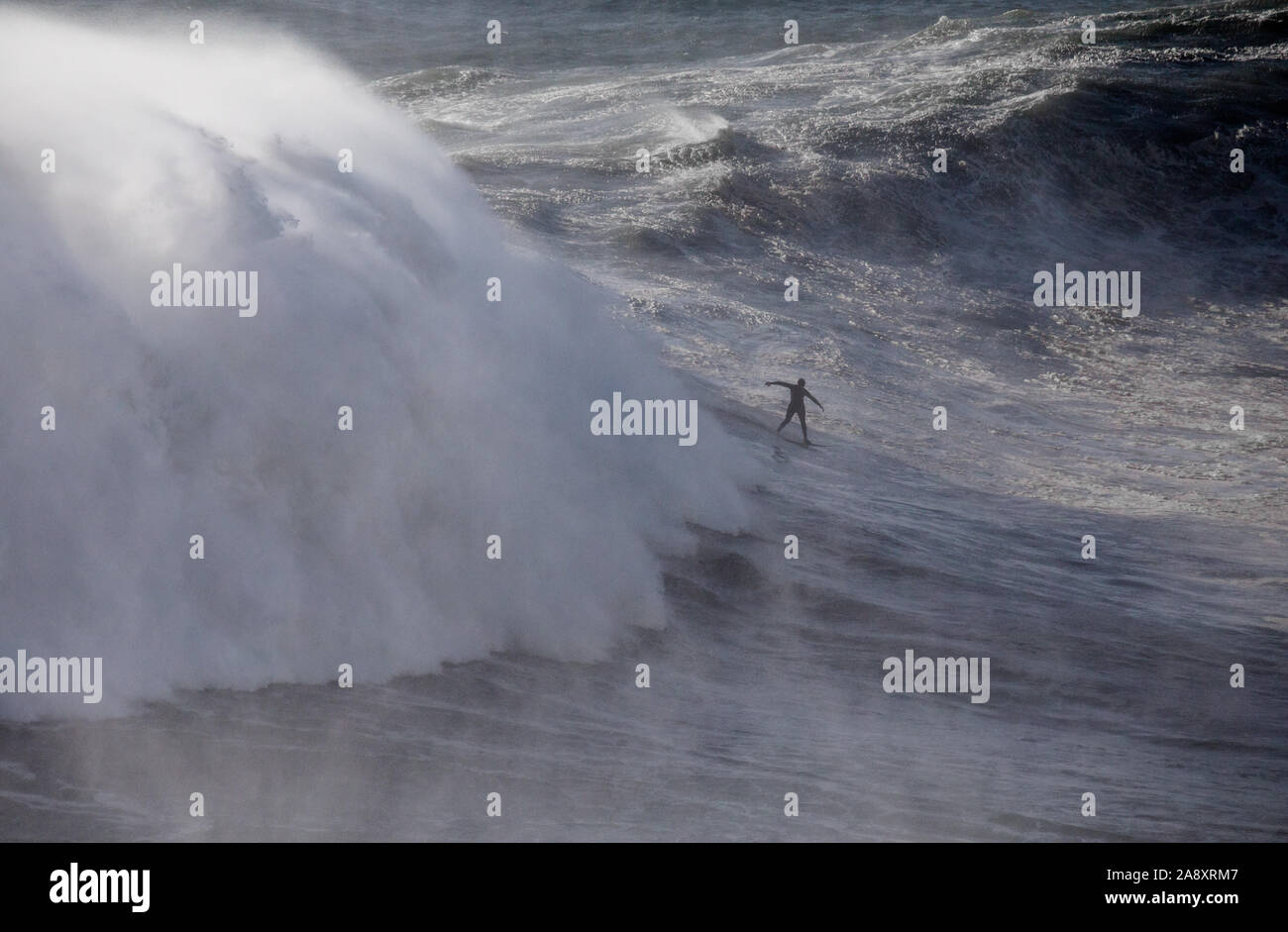 Surfing Big Waves in North Beach, Nazare, Portugal Stock Photo - Alamy