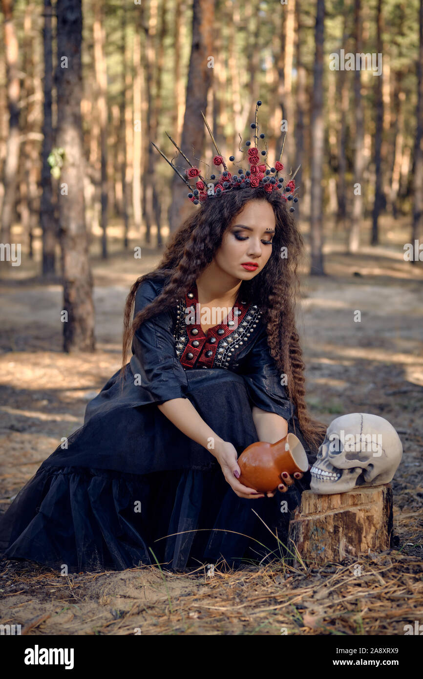Beautiful, wicked, long-haired charmer in a black, long embroidered ...