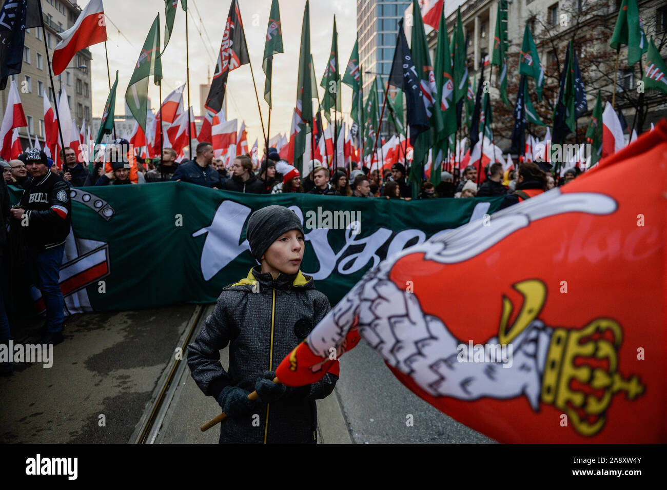 Warsaw, Poland. 11th Nov, 2019. A boy holds a Polish flag in front of a ...