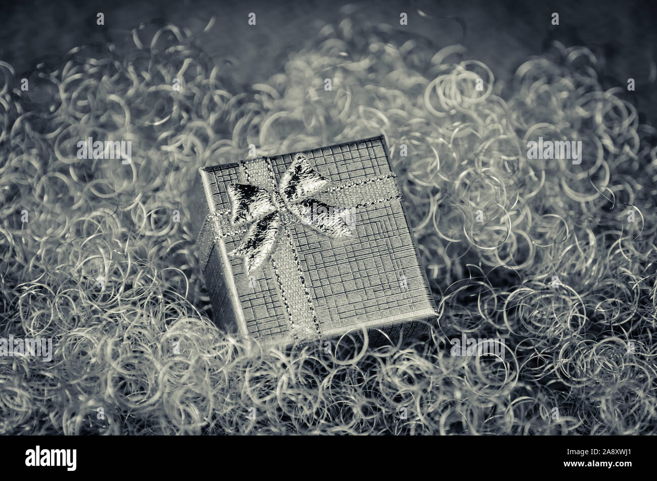 shining silver christmas box with surprise inside in silver background ...