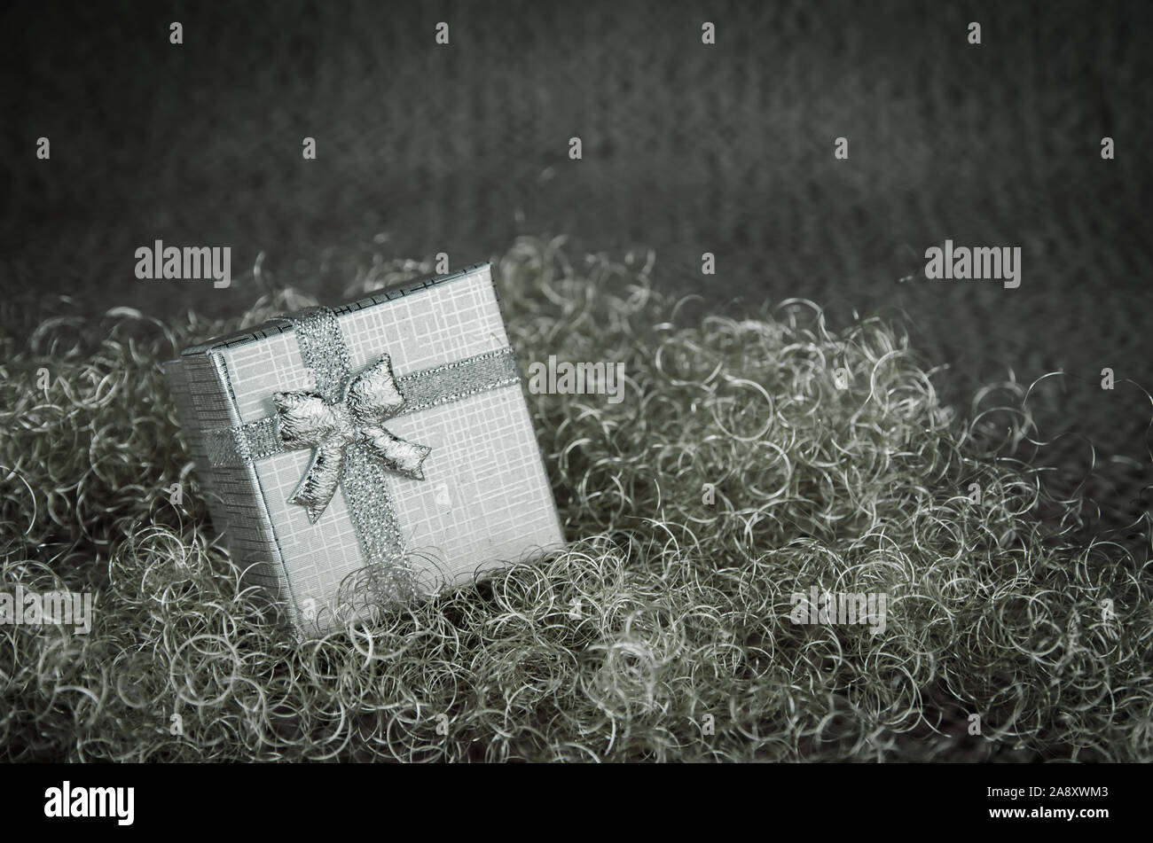 shining golden christmas box with surprise inside in silver background ...