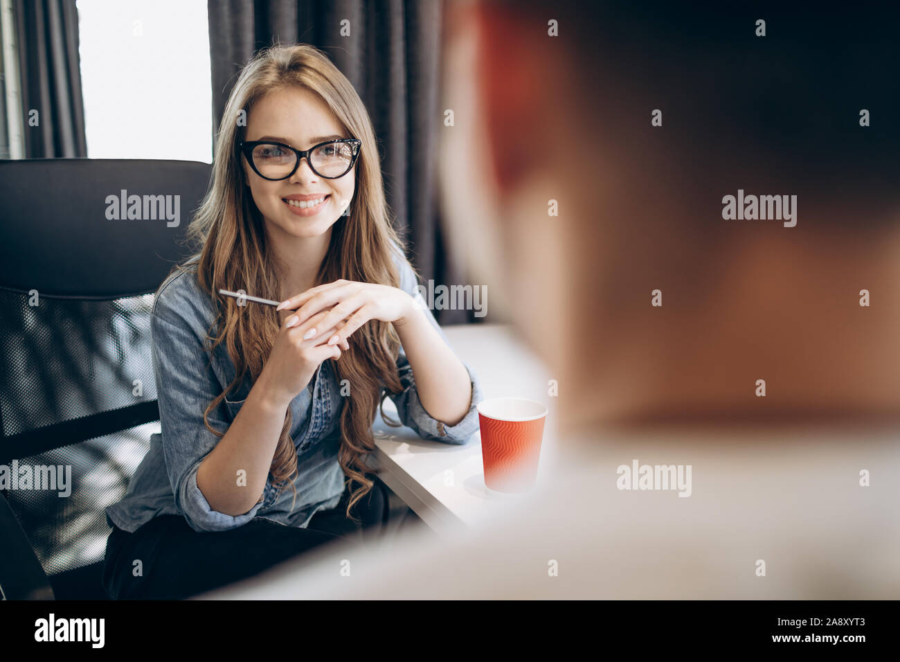 A Cute Female Recruiter Interviewing an Applicant Stock Photo - Alamy